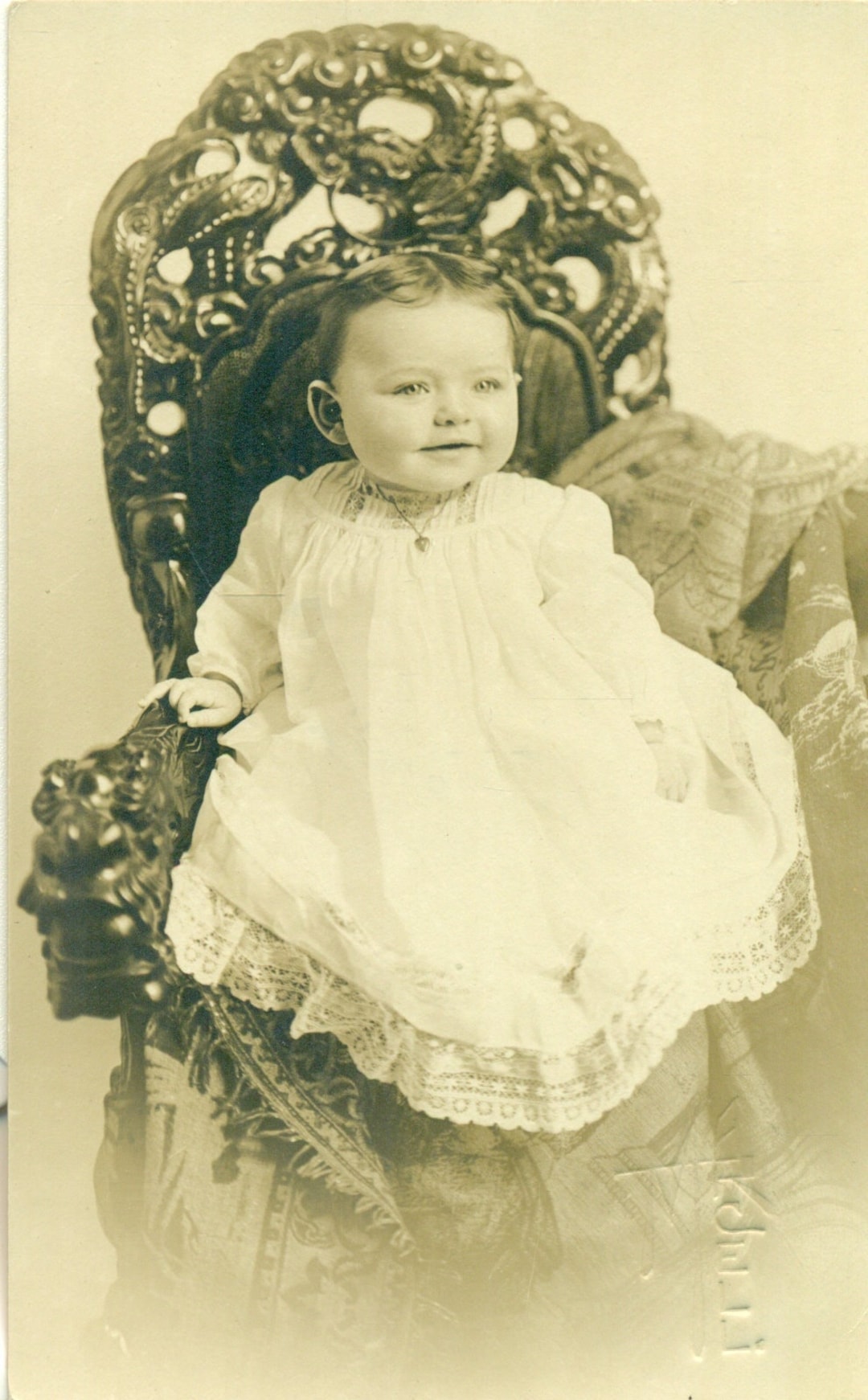Intent Baby Girl Looking at Photographer Wearing Necklace Carved Chair ...