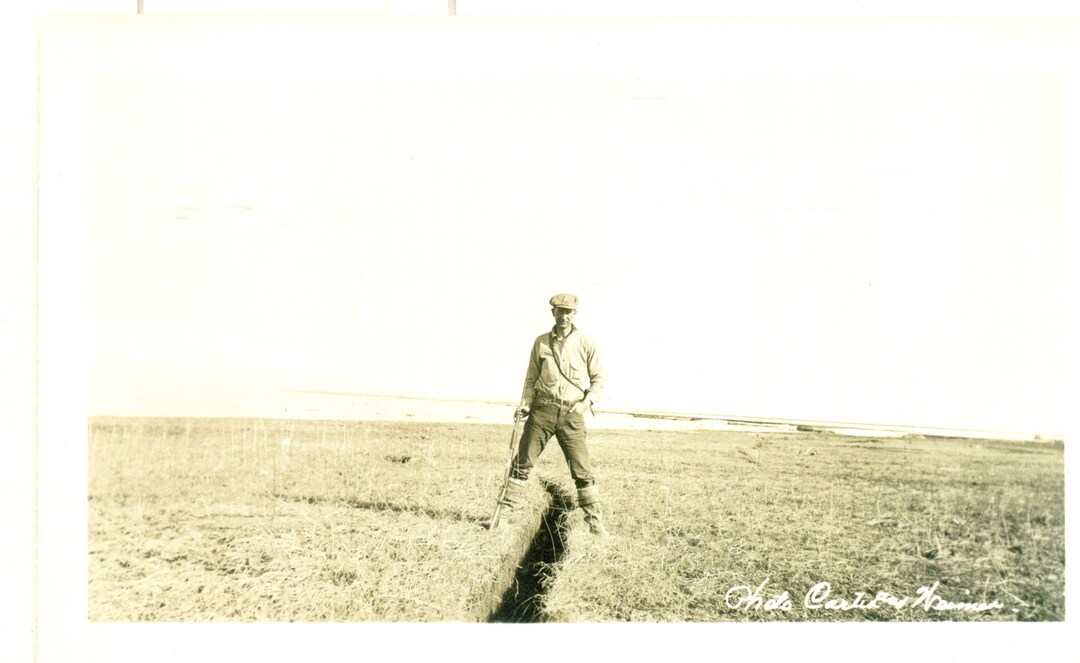1920s Alaska Man Standing Over Trench Fault at Shore Holding Gun Sepia ...
