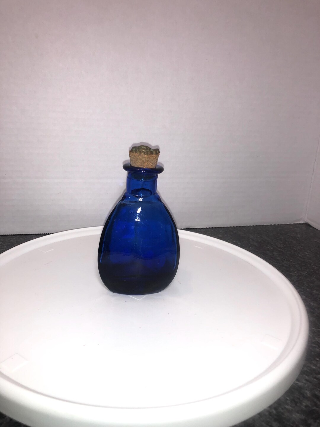 Vintage Cobalt Blue Triangle Bottle Poison Perfume Rose on Top of Wood ...