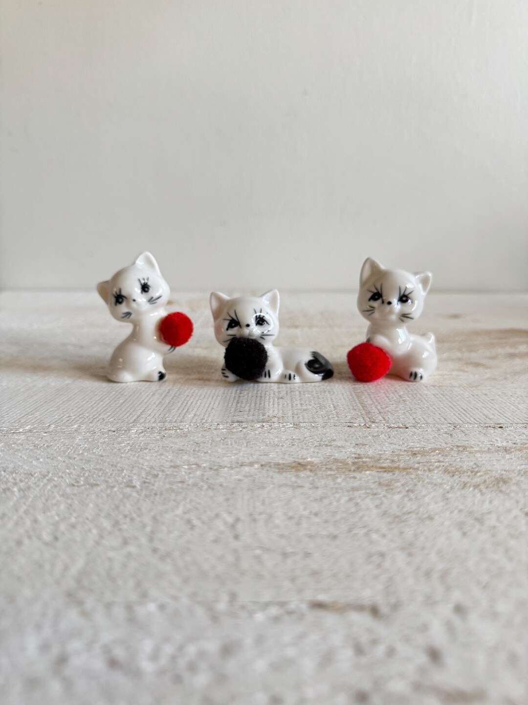 White Ceramic Cat Figurines White Cats Holding Red and Black Pompom ...