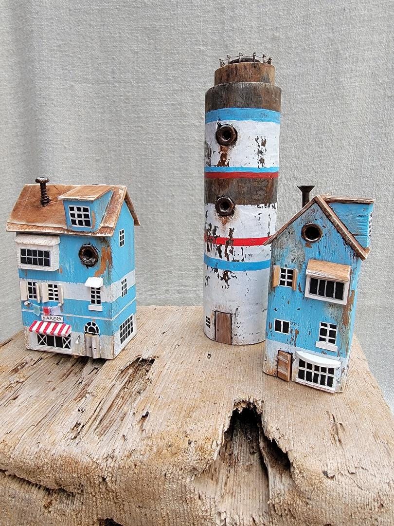 Miniature Houses and a Driftwood Lighthouse Overlooking the Ocean ...