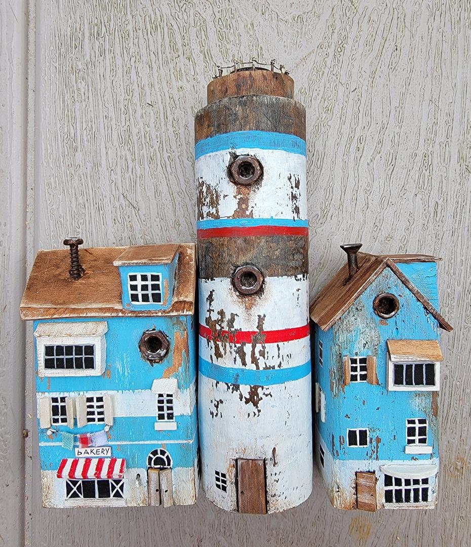Miniature Houses and a Driftwood Lighthouse Overlooking the Ocean ...