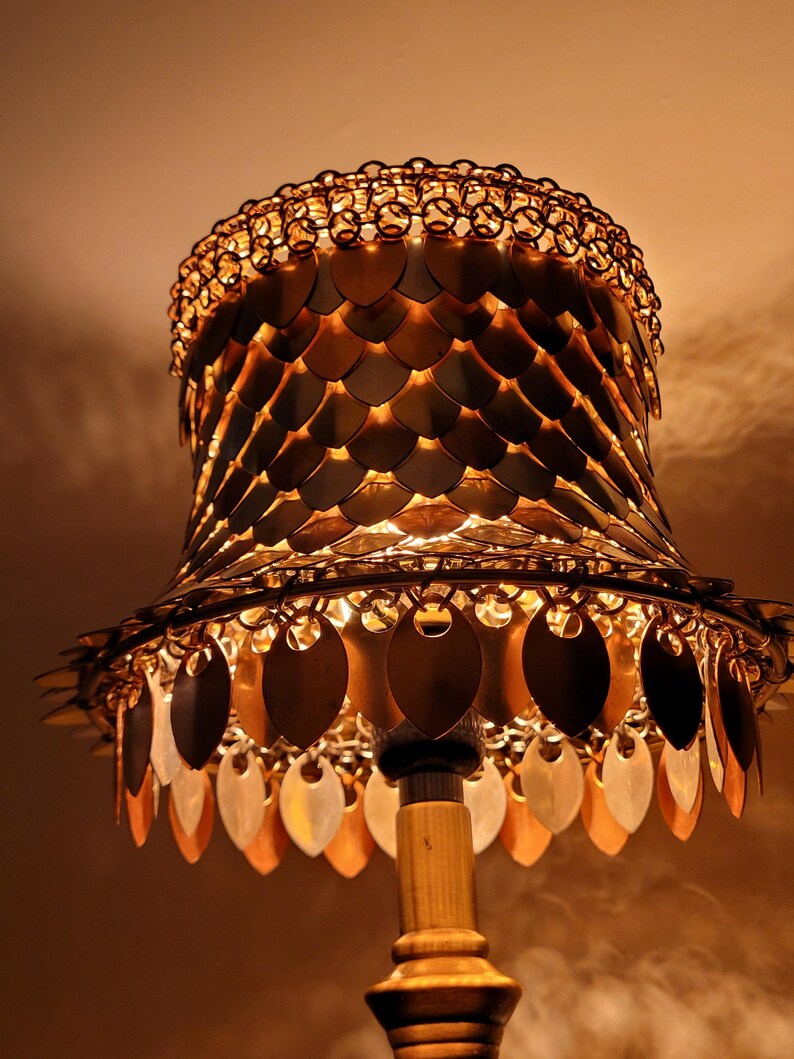 Medieval Multi Color Metal Dragon Scale Lampshade Atop A Pedestal Table ...