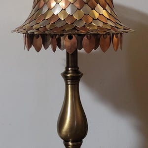 Medieval Multi Color Metal Dragon Scale Lampshade Atop A Pedestal Table ...
