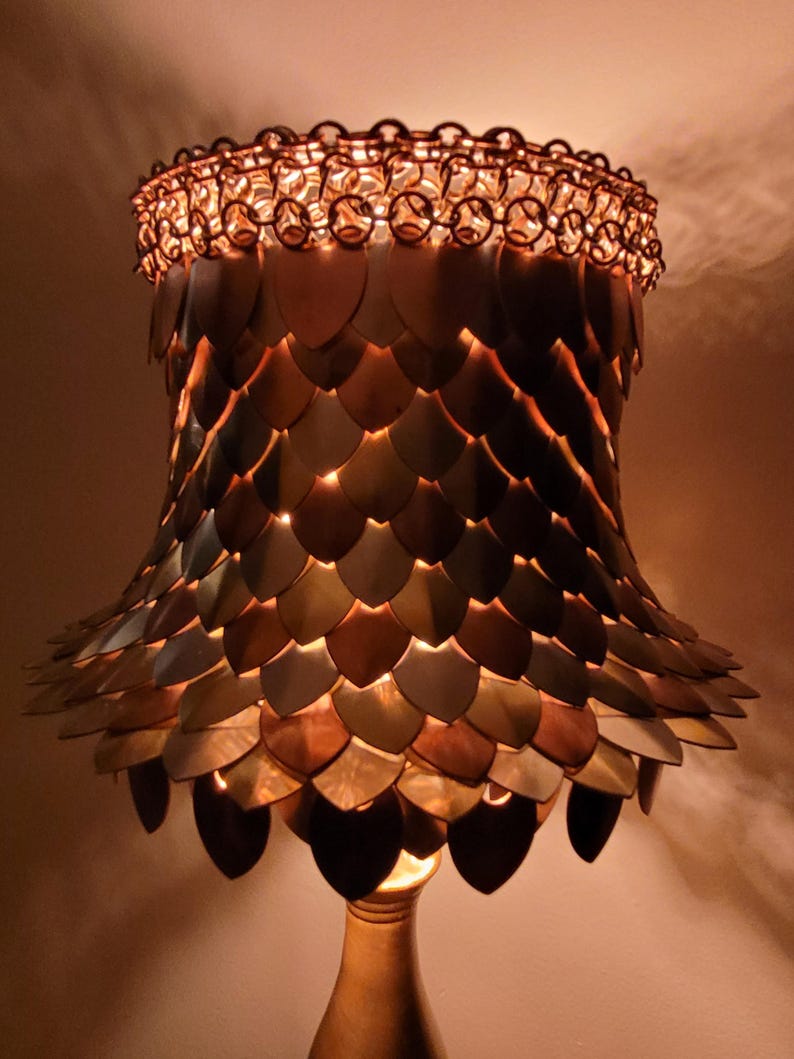 Medieval Multi Color Metal Dragon Scale Lampshade Atop A Pedestal Table ...