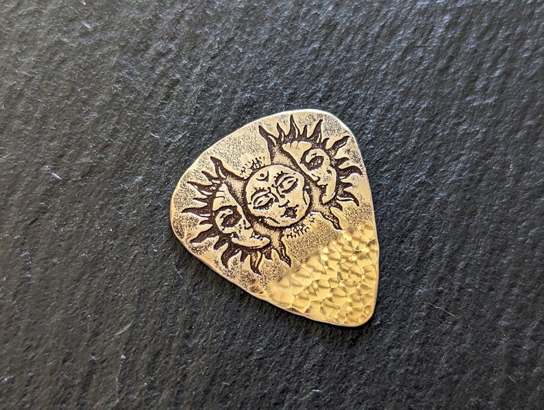 Brass Guitar Pick With a Three Face Sun and a Hammered Sparkly Texture ...
