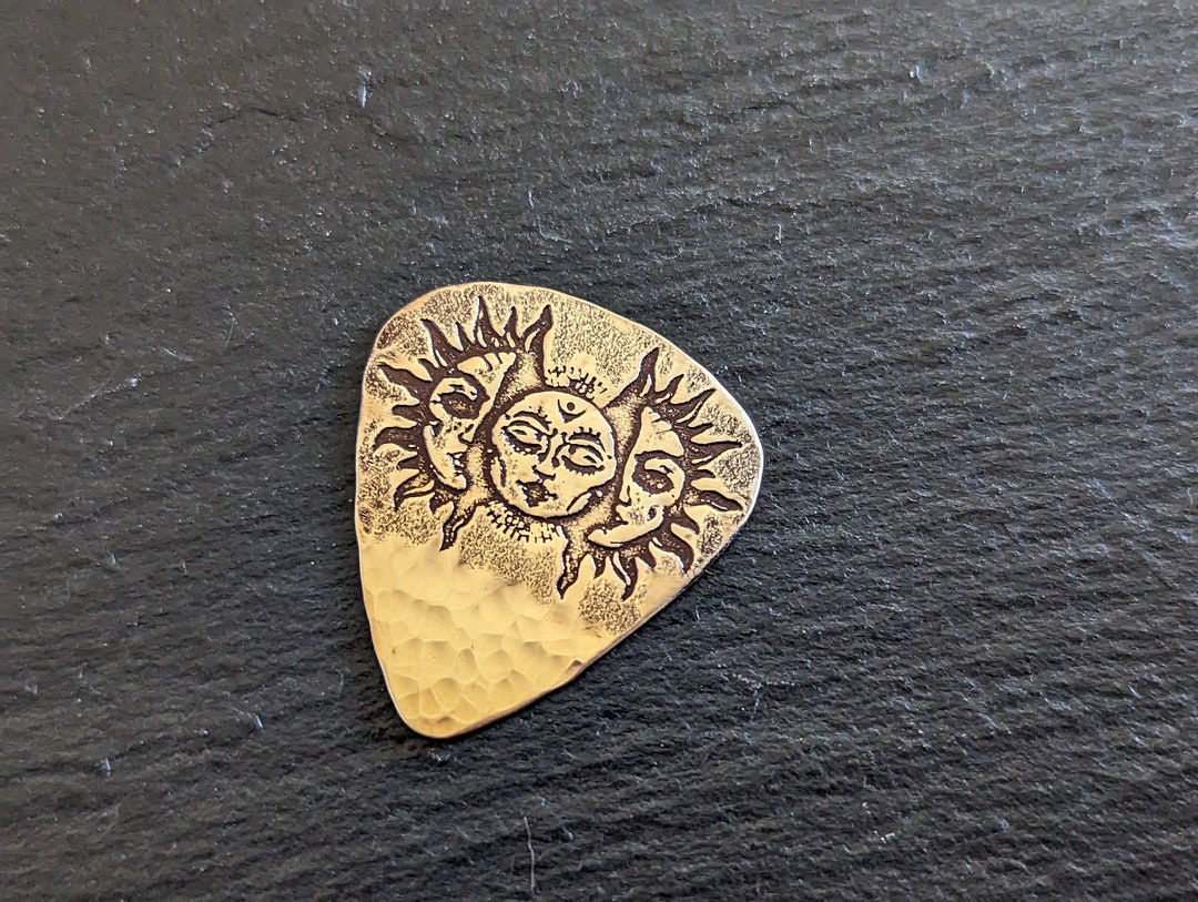 Brass Guitar Pick With a Three Face Sun and a Hammered Sparkly Texture ...