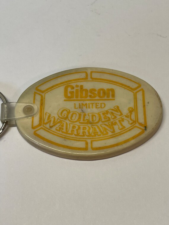 Vintage Gibson Golden Warranty Rubber Keychain - Gem