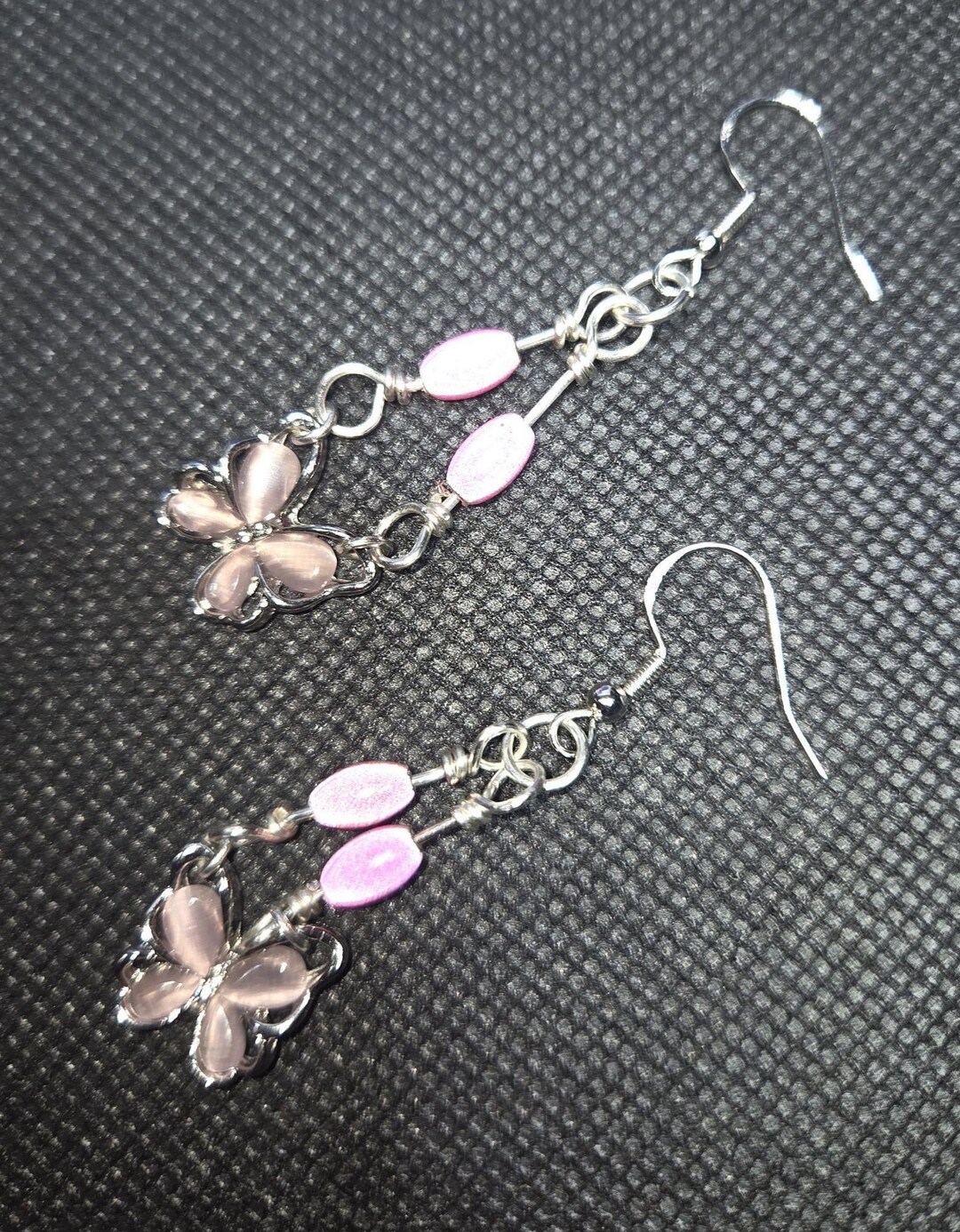 Pink Butterflies Elegantly Suspended on Vibrant Hot Pink Oval Beads. A ...