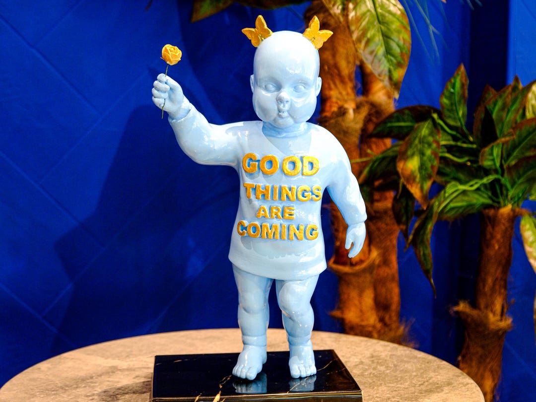 Blue Baby Statue With Gold Text – ‘good Things Are Coming ...