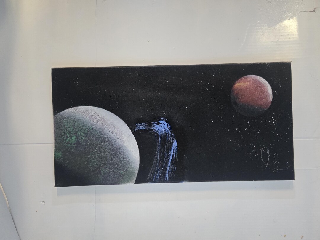 Cosmic Spray Paint Art of a Red Planet and a Green Planet With Rings on ...