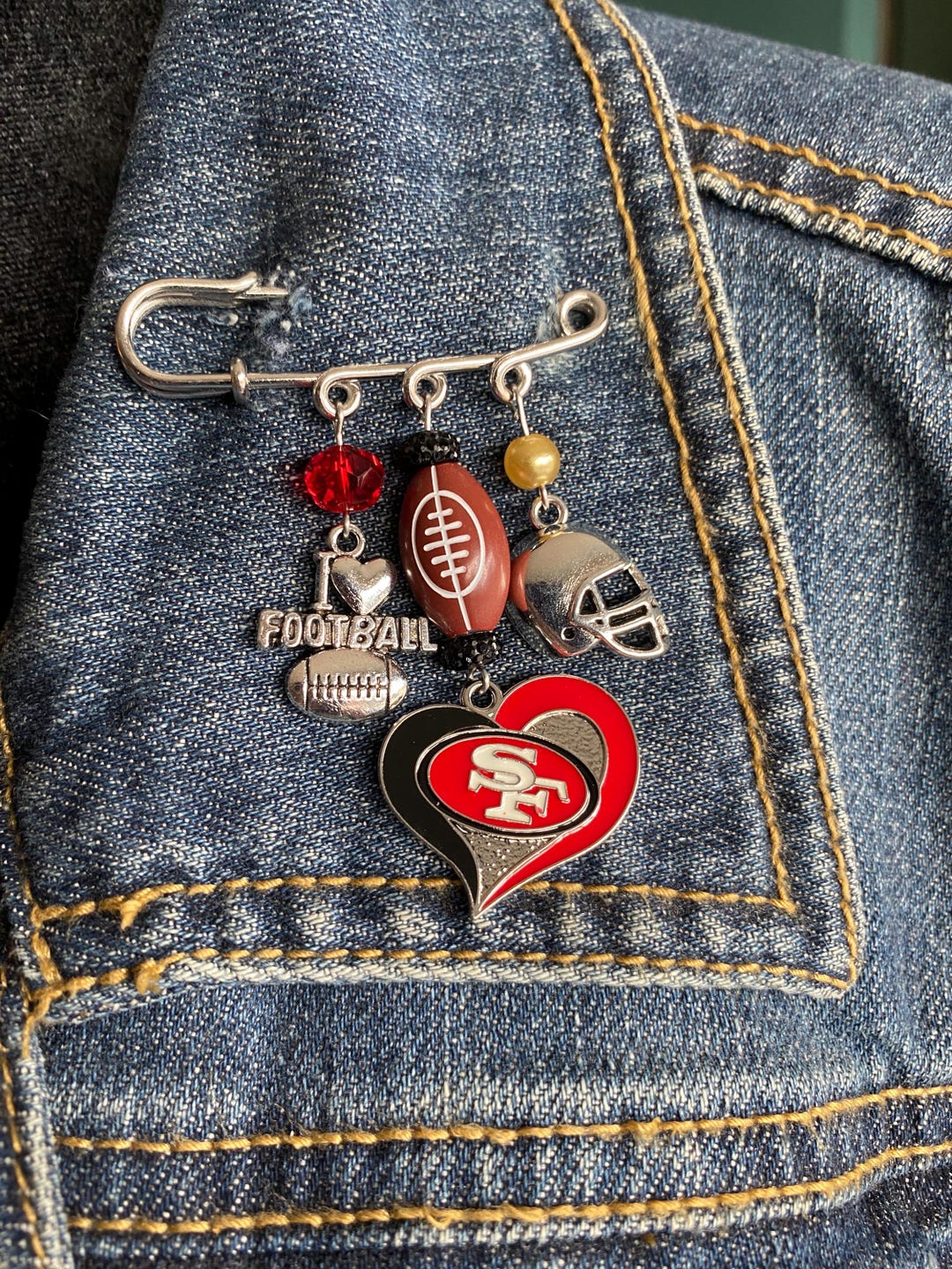 San Francisco 49ers Football Safety Pin. There is a 49ers Charm, a ...
