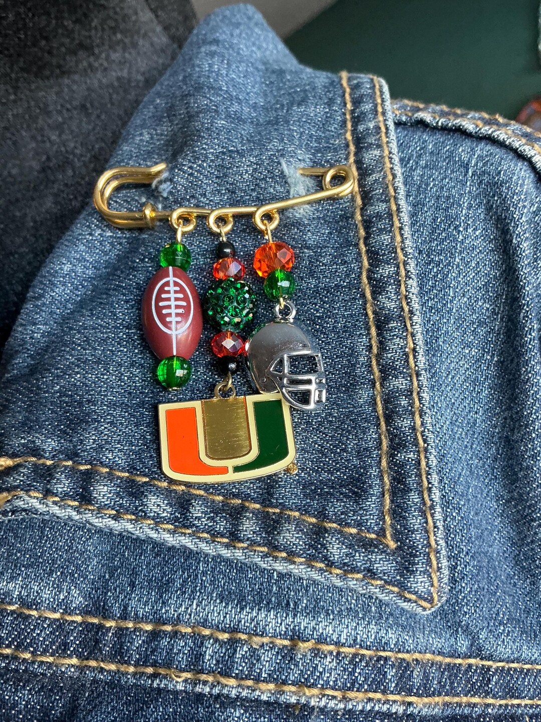 University of Miami Hurricanes Gold Safety Pin. There is an University ...