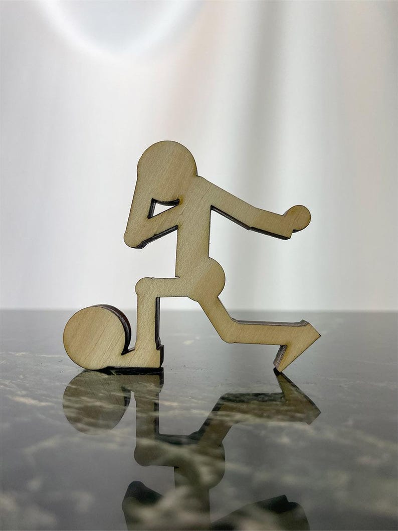 Dynamic Striker – A Laser-cut Soccer Player Mid-kick, Capturing Speed ...