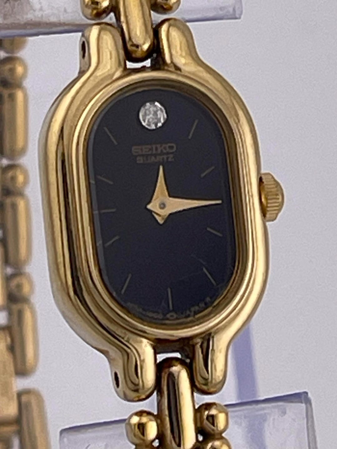Seiko Women’s Quartz Watch 1E20-6039 – Gold Tone Oval Case – Black Dial ...