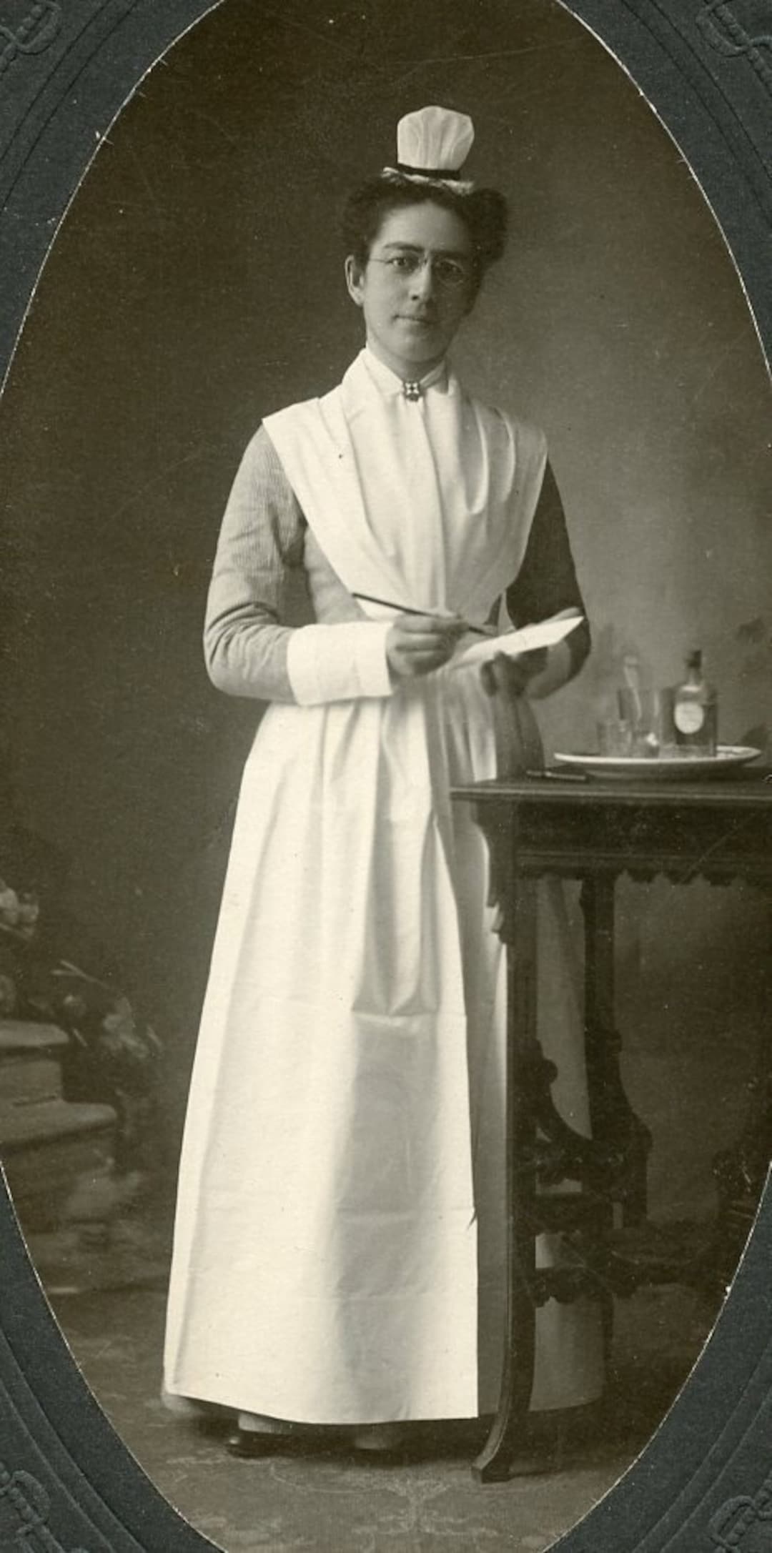 NURSE TAKING NOTES Standing Next to Medicine - C1910 Cabinet Photo by C ...