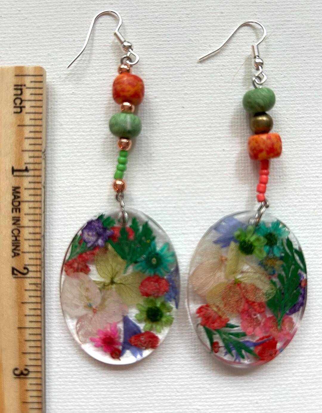 Salient. Green and Orange Beads Enhance the Plant Material in These ...