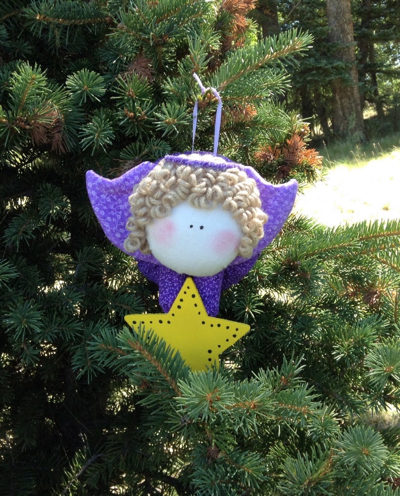 Primitive Sandy Blonde Angel With Purple Body and Purple Wings Holding ...