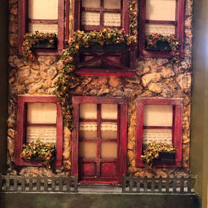 Charming Miniature Stone House With Red Accents and Flower Details ...