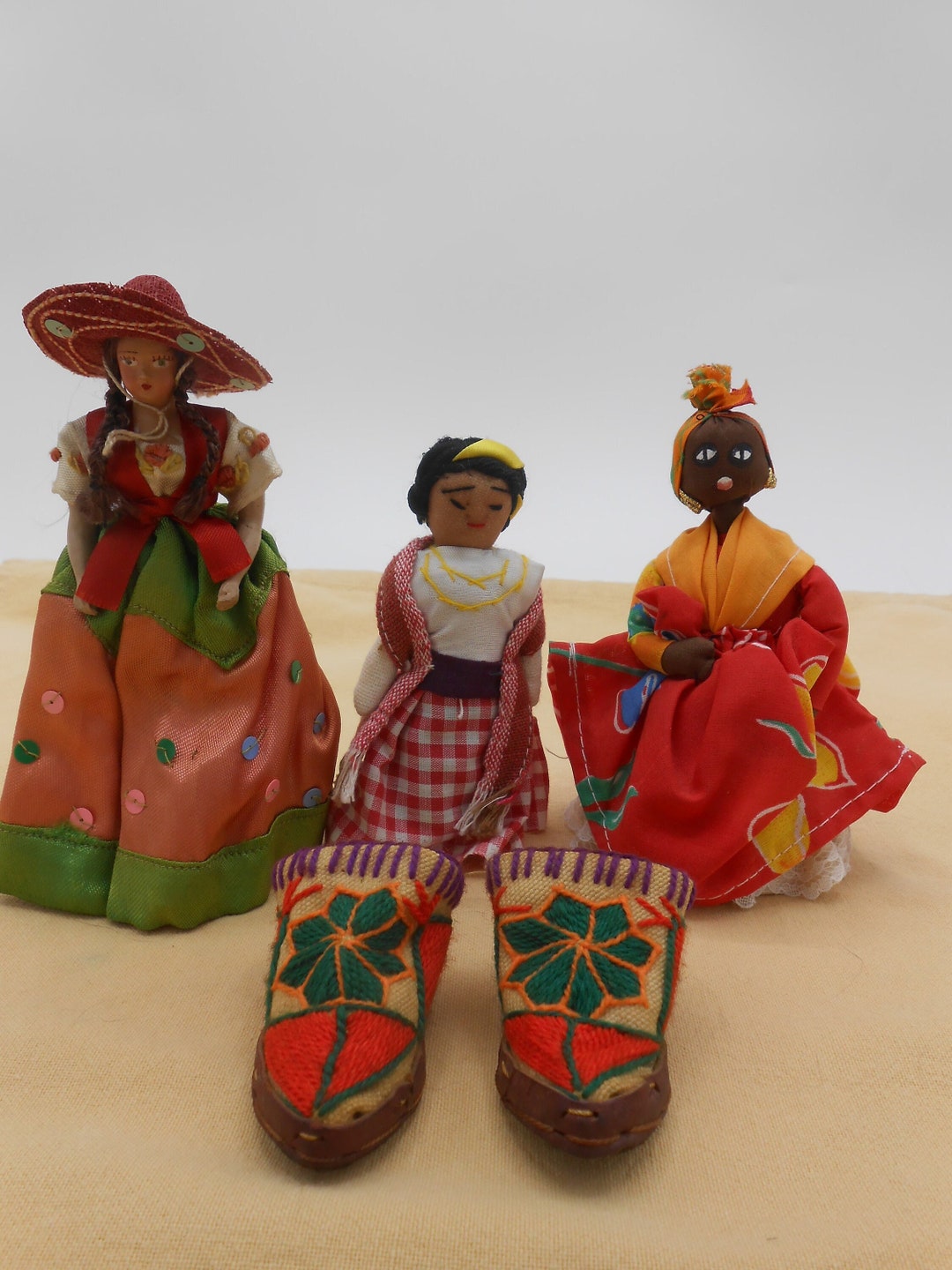Three Latin Costume Dolls and Pair of Embroidered Doll Shoes, South ...