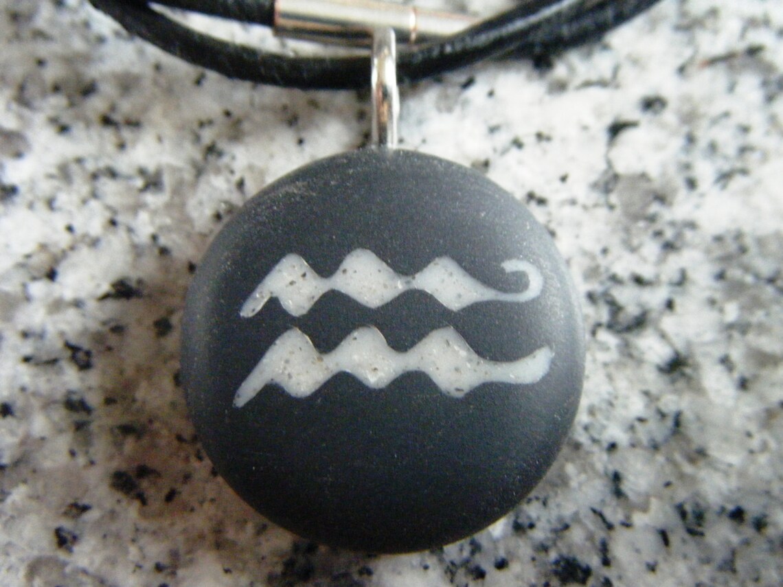 Aquarius Zodiac signs hand carved on a polymer clay black | Etsy