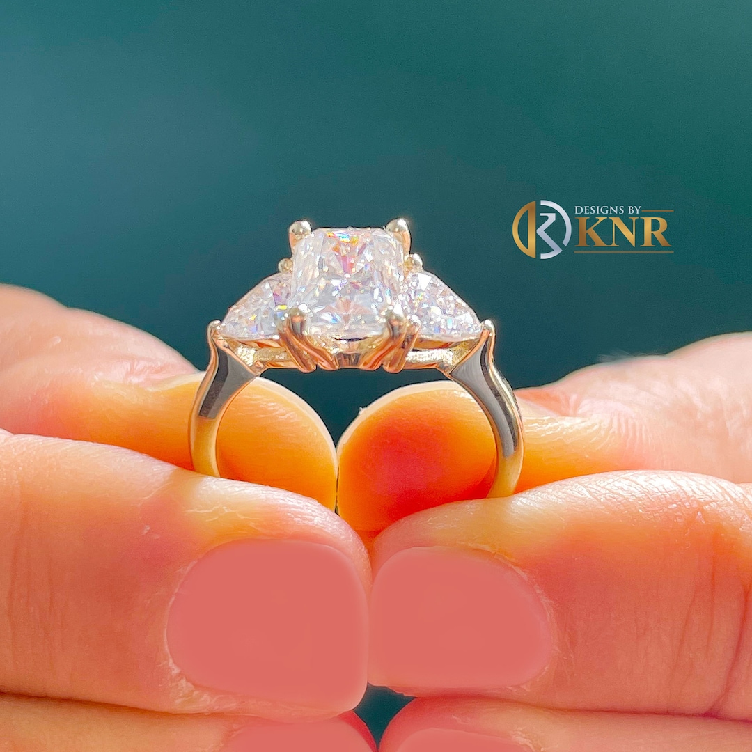 Radiant diamond with trillion side stones store