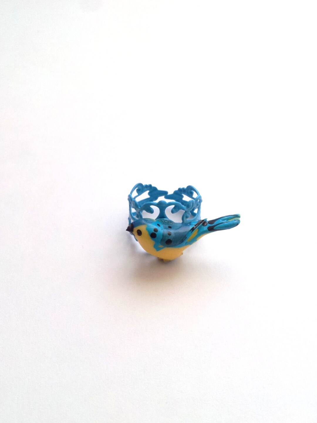 Blue Yellow Green Bird Ring Fixed on on Turquoise Blue Filigree ...