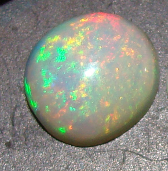 Items similar to 2ct Oval Ethiopian Opal 9mm x 9.8mm Great Play of ...