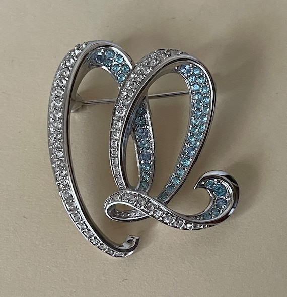 Swarovski clear, blue crystals swirl, letters brooch.… - Gem