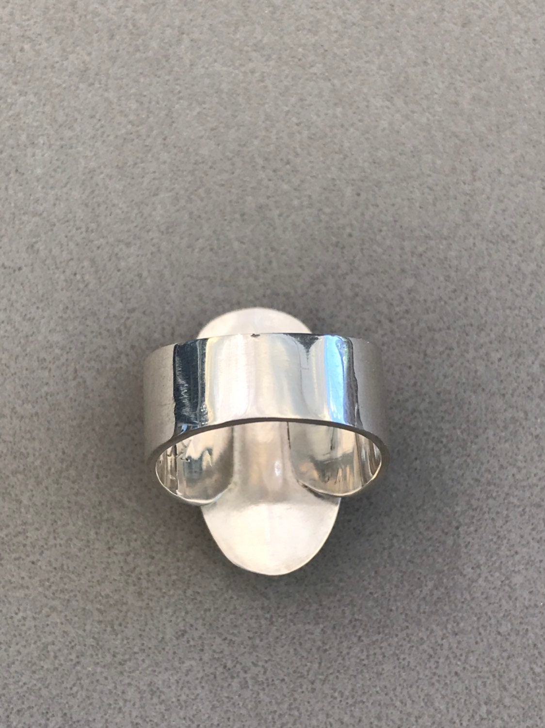 Pipe crystal opal ring in a gold bezel on a wide band of silver