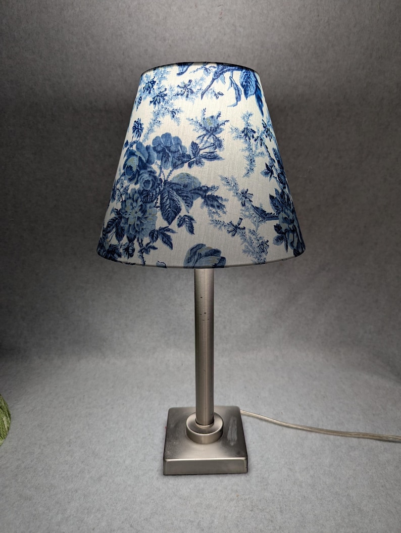 Vintage Look Blue Flowers Lamp Shade. Plants. Light Blue Background ...