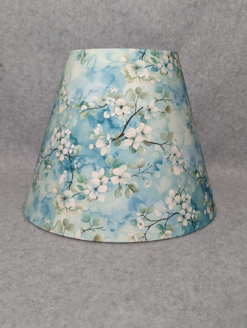 Cherry Blossoms on Blue Lamp Shade. Shades of Blue Background. Colorful ...