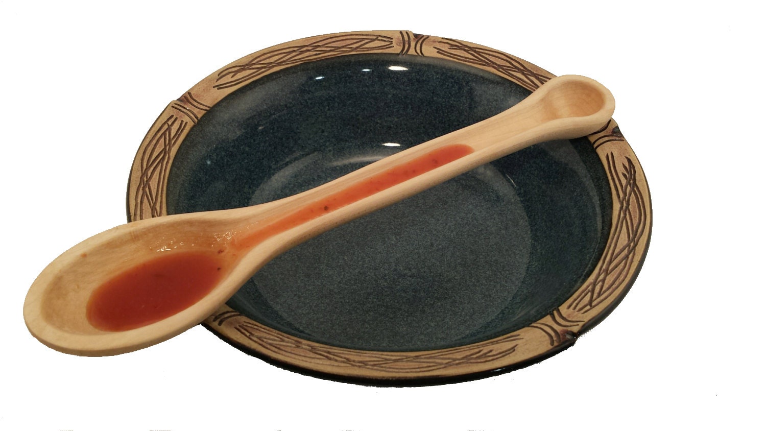 Wooden spoon like object with a channel that curves downward and is ...