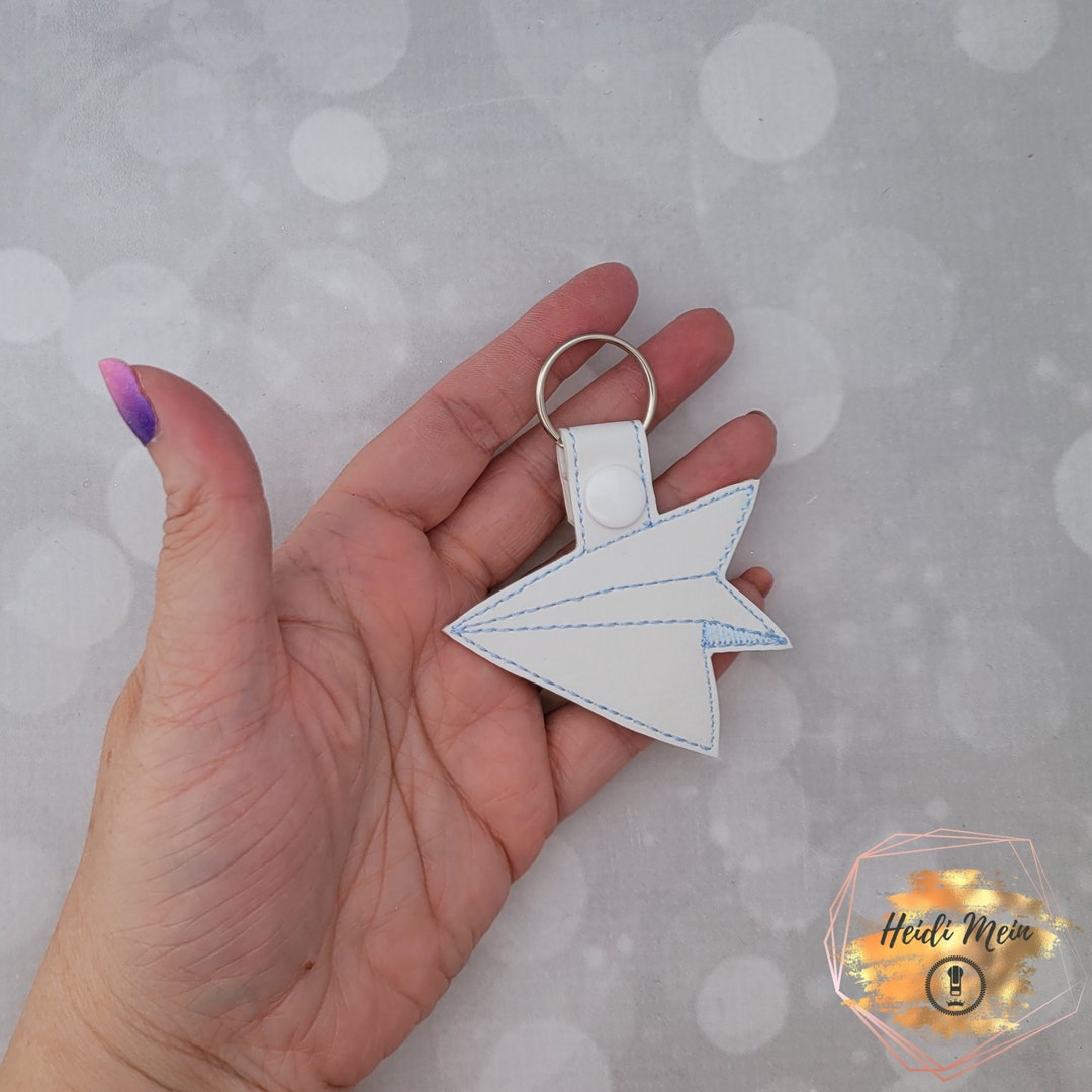 Flight of Fun: Paper Airplane Snap Tab Keychain in Embroidered Marine ...