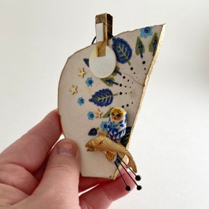 Quirky Found Object Mixed Media Collage Folk Art. Nesting Doll Riding a ...