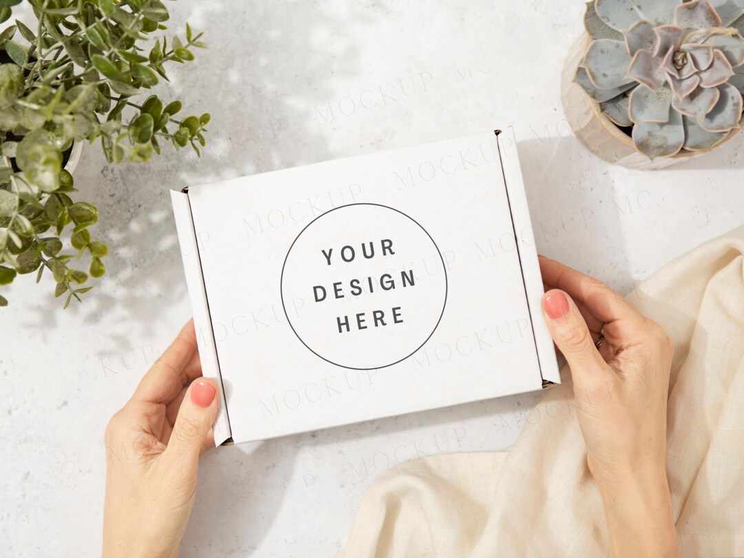 White Cardboard Gift Box Packaging Mockup With Hands and Plants ...