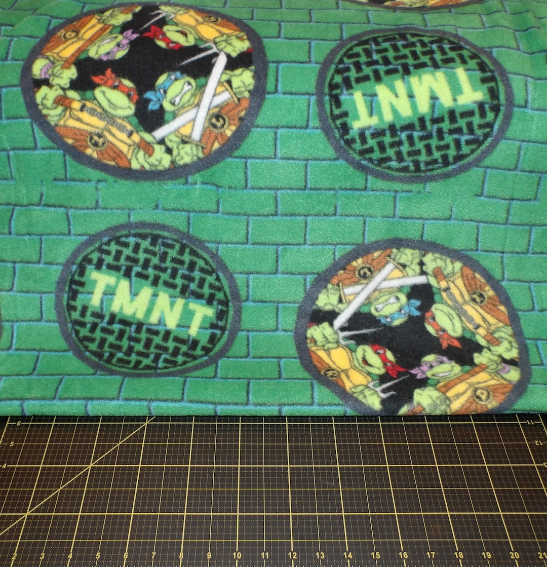 Springs Creative. TMNT Badges Fleece 58/60 Wide Teenage Ninja Mutant ...