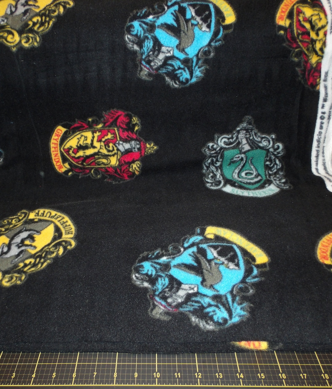 Camelot Fabrics. Wizarding World. Harry Potter House Crests Tossed in ...