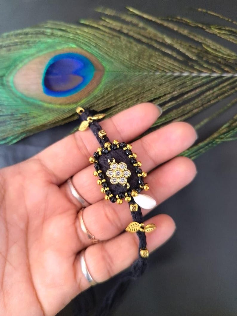 Handmade Black Gold Panchmashi Rakhi | Cotton Potli, Beaded Bracelet ...