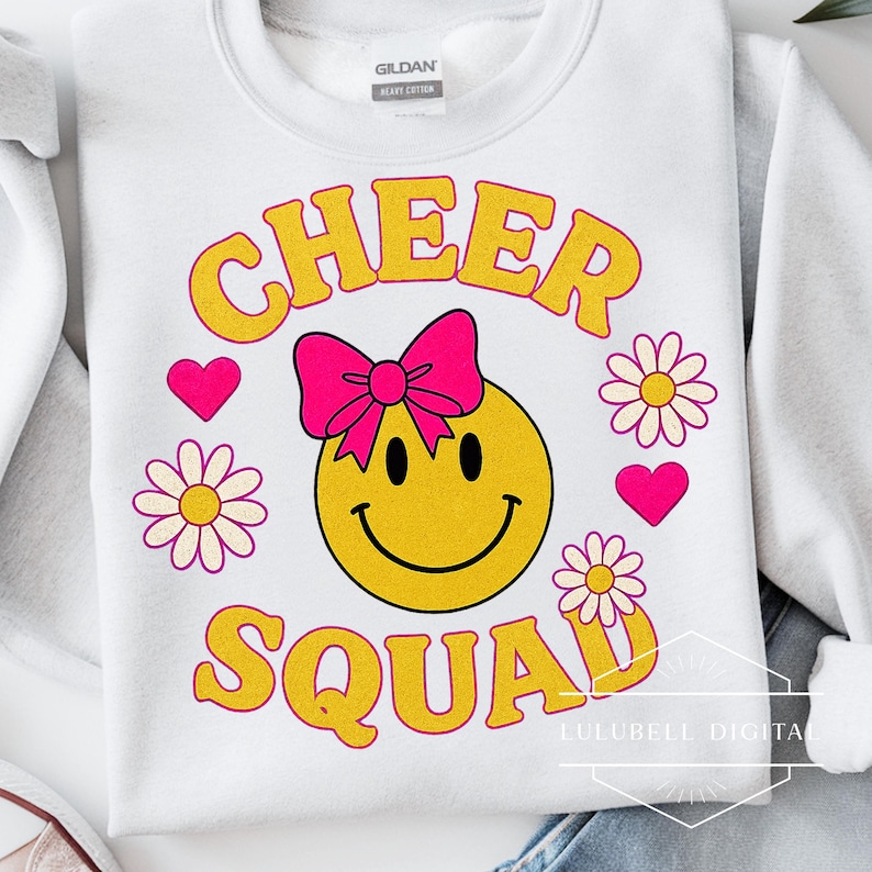 Cheer Squad PNG: Happy Emoji Face & Bow T-shirt Graphic, Daisy Hearts ...