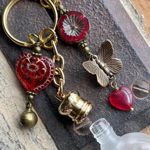 Perfume Bottle Keychain With Hearts, Butterfly and Bells Purse Charm ...