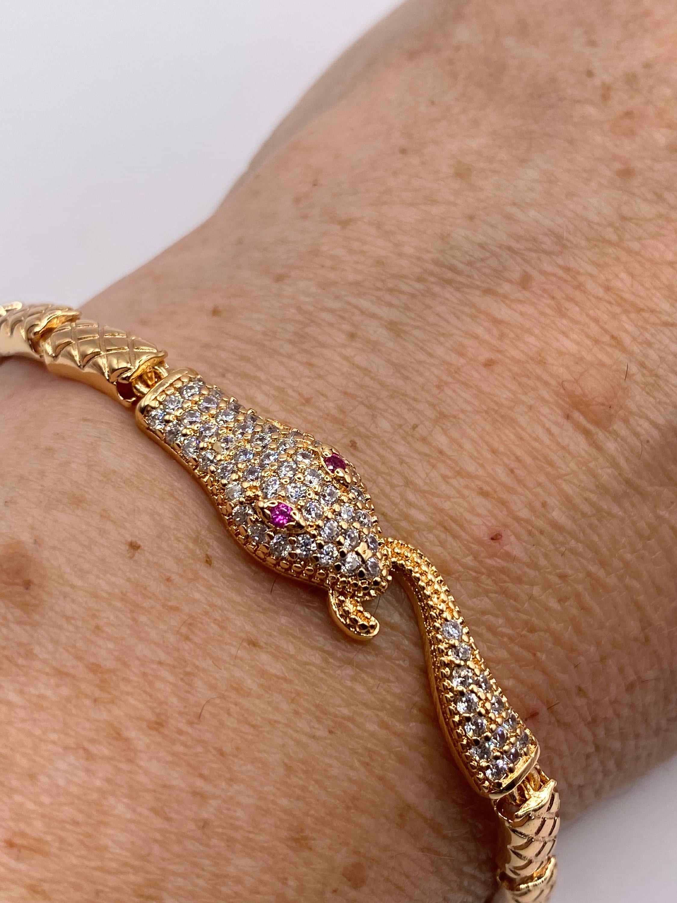 Gold snake bracelet with ruby eyes store