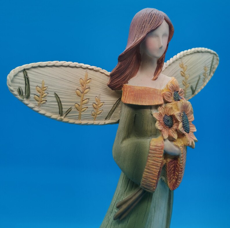 Vintage Decorative Angel Figurine Featuring Sunflower Details and ...