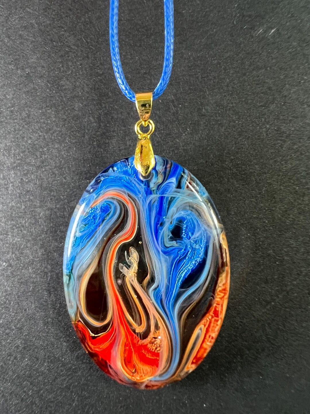 Fire and Ice: Wispy Orange and Blue Tones Fill This Oval Pendant and ...