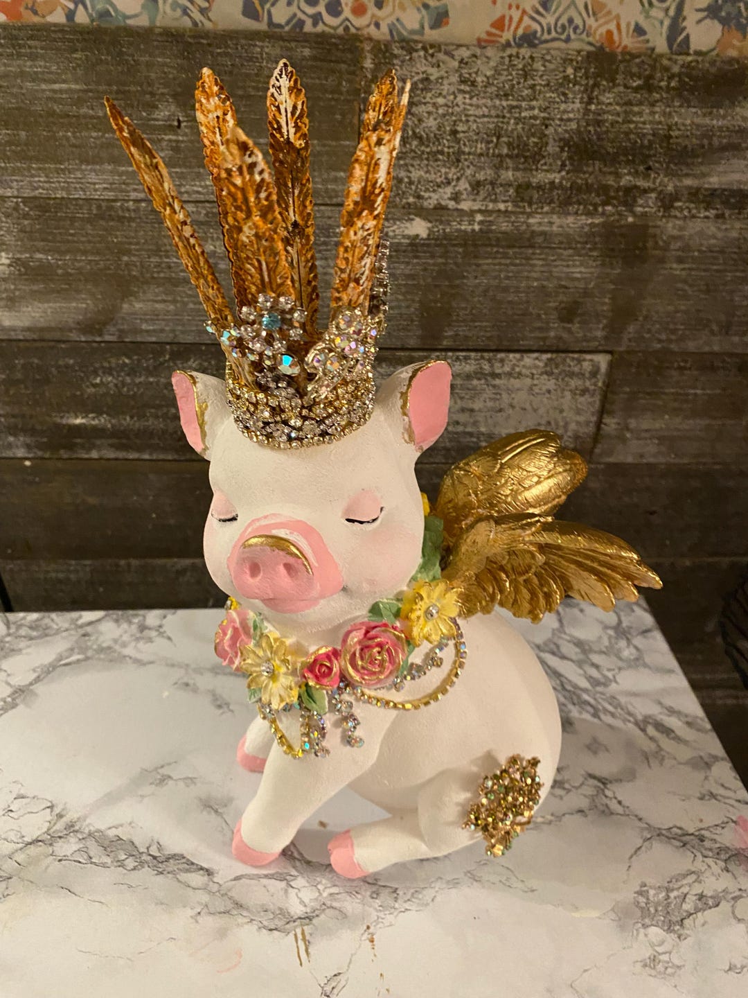 A Large and Colorful Flying Pig Statue, a Tall Feathered Crowned Pig ...