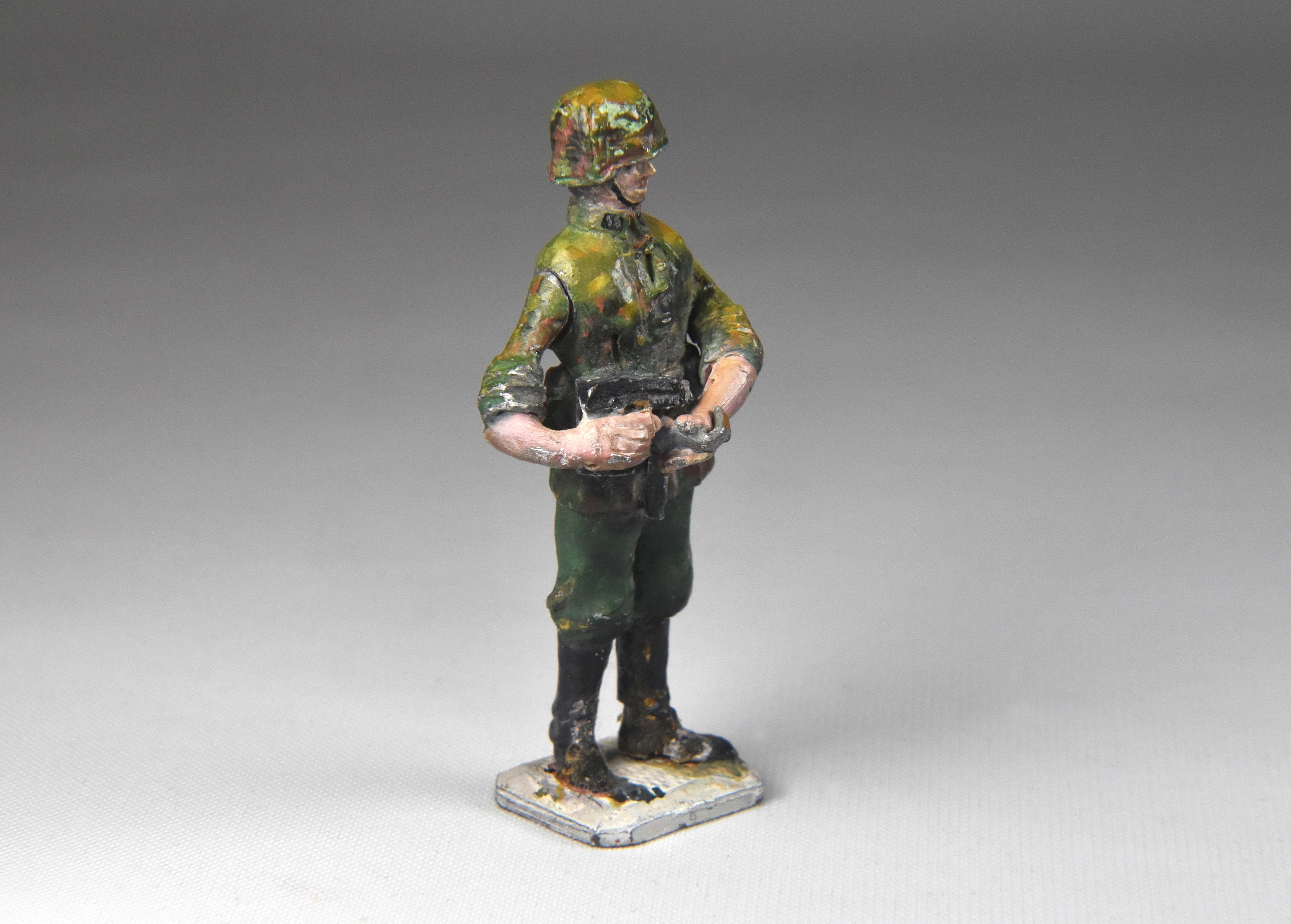 Small Metal Toy Soldier Wearing Green Fatigues and Carrying a Weapon ...