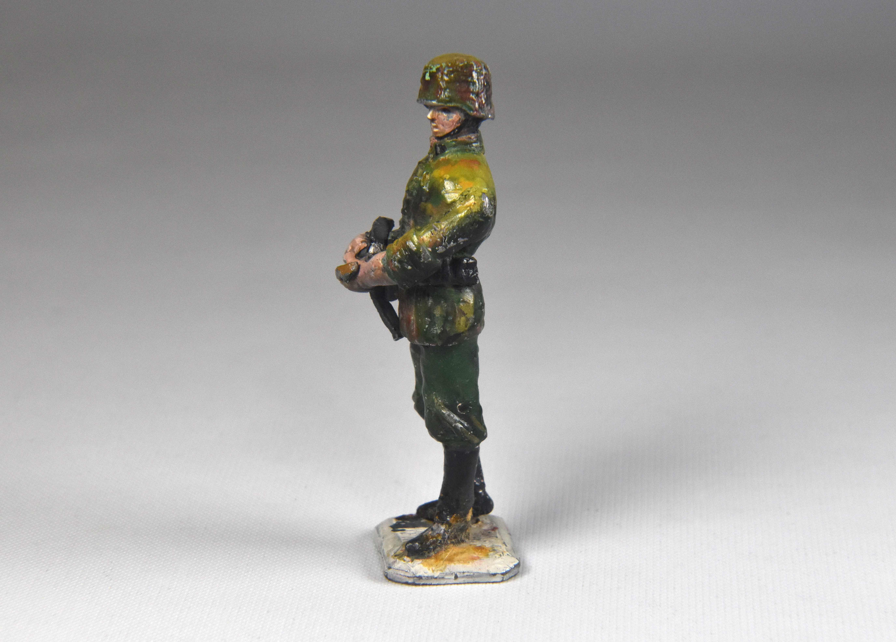 Small Metal Toy Soldier Wearing Green Fatigues and Carrying a Weapon ...