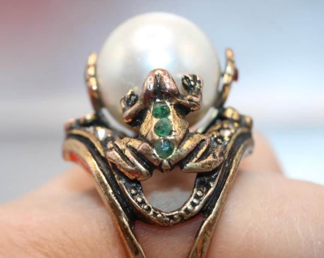 Alcozer Ring. It Features a Crown With Rubies and Two Frogs With ...