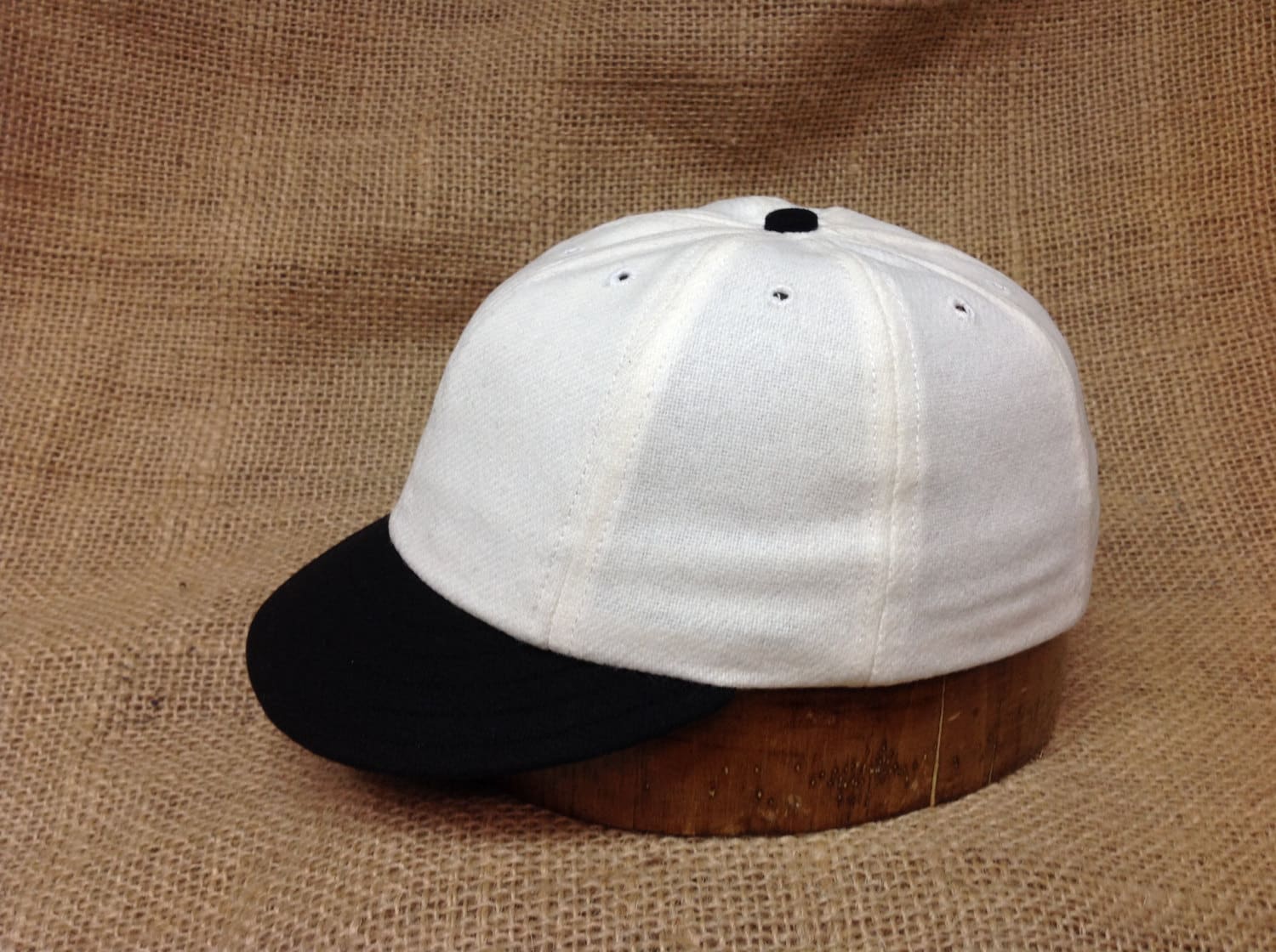 White wool flannel 8 panel cap with black 1910 visor. Fitted to any size.