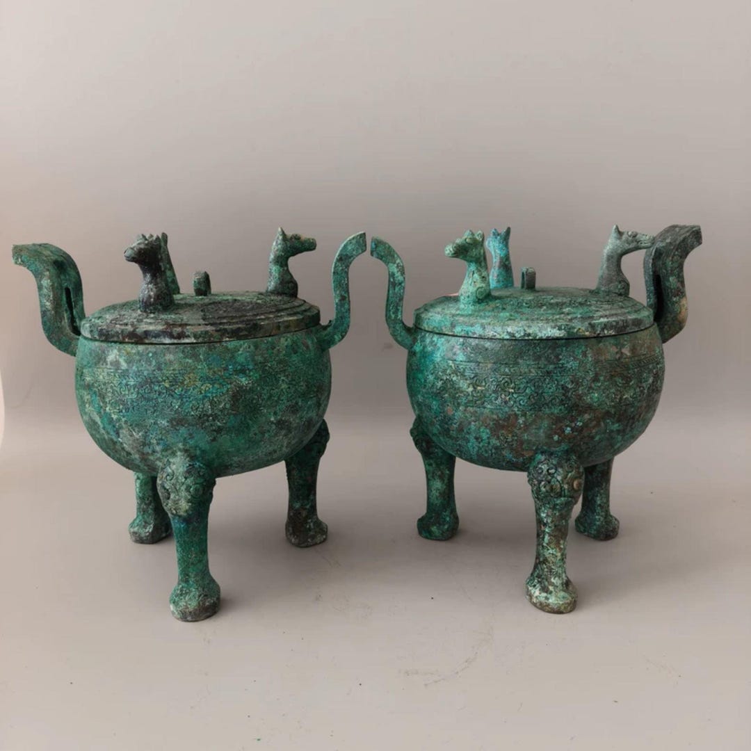 A Three-legged Covered Bronze Tripod With Animal Face Patterns From the ...